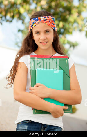 Pretty Twelve Year Old Student with a book outdoor Stock Photo - Alamy