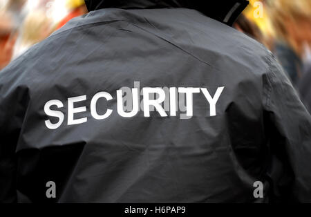 Security guard in front of crowd Stock Photo - Alamy