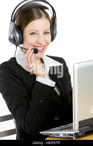 A female switchboard operator speaks into a headset while operating a ...