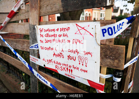 Warning sign for a haunted house Stock Photo - Alamy