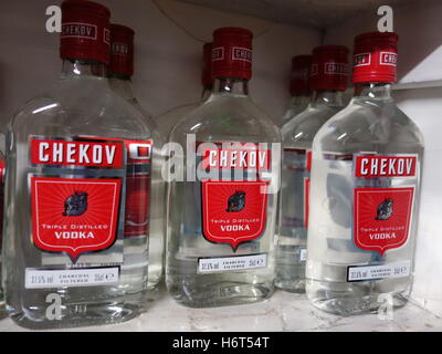 Russian vodka. Bottles of Smirnoff vodka on a shelf in duty free shop ...