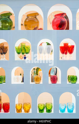 Colored glass cups on showcase Stock Photo - Alamy