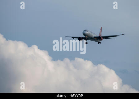 Massachusetts, Boston. Jet flying into Boston Logan airport at sunset ...