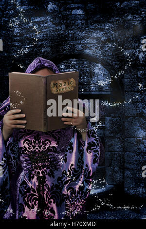 Halloween witch reading in her book of shadows Stock Photo - Alamy