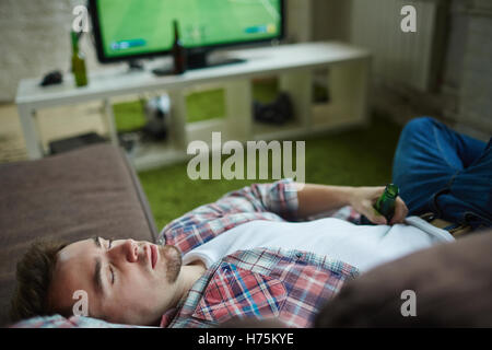 Young man napping on soccer field at park Stock Photo - Alamy