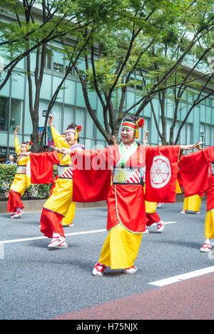 Yosakoi festival, Japan. Young female dance troupe in black and yellow ...