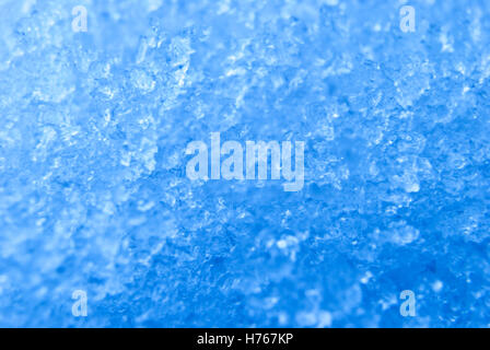 Blue-tinted ice-melt melting snow on pavement Stock Photo - Alamy