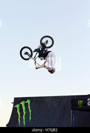 A person doing a back flip over a jump on a BMX bicycle Stock Photo - Alamy