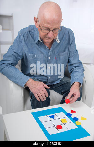 Alzheimer's disease test. Elderly man completing a multiple choice test ...