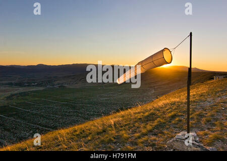 paraglider white windsock at sunset in mountains against sun Stock ...
