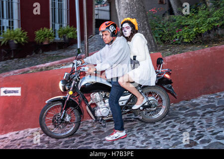 Woman dressed for Halloween with motorcycle on dark background Stock ...
