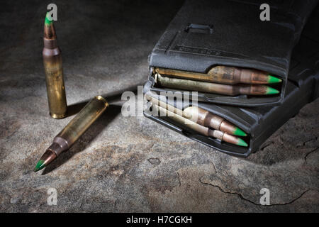 Two rounds that are loaded with polymer tipped bullets on a graphite ...