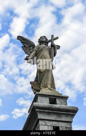 Photograph of an Angel and religious Cross sculpted statue Stock Photo ...