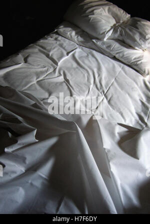 Crumpled unmade bed in hotel. Messy bed with used linens, bed sheet and ...