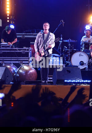 Singer performs on the stage illuminated by lights Stock Photo - Alamy