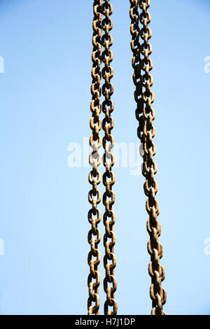 Long metal chains hanging vertically against blue sky Stock Photo - Alamy