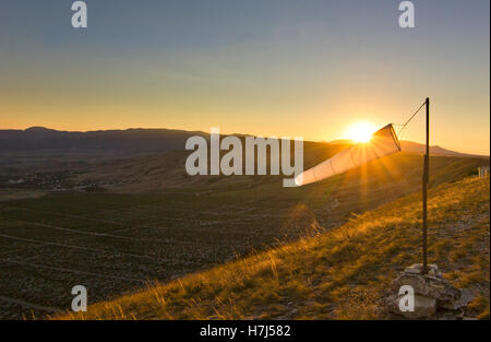 paraglider white windsock at sunset in mountains against sun Stock ...