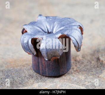 Copper plated hollow point bullet expanded after impact Stock Photo - Alamy
