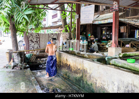 A guy washing himself in the streets of Mandalay, Burma (Myanmar Stock ...