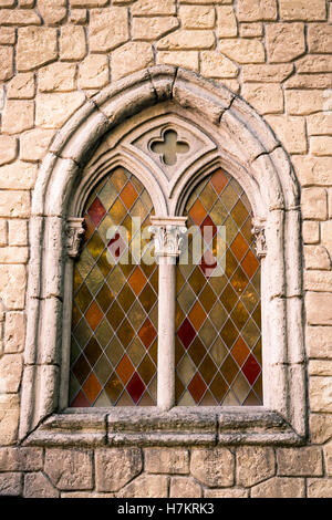 Castle window in a medieval style. Double arched window on a facade of ...