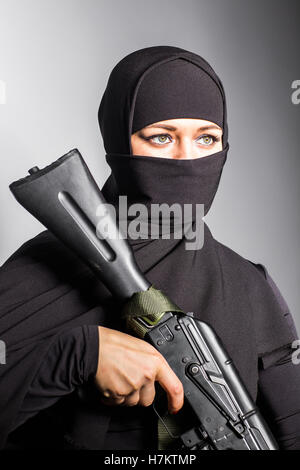 Close-up of muslim woman with a gun Stock Photo - Alamy