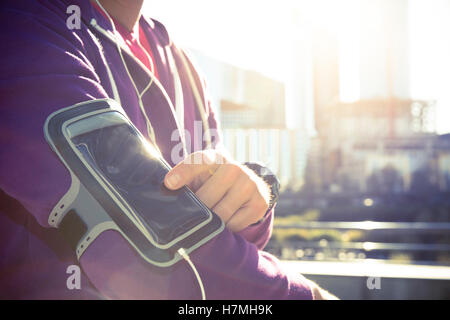 Running workout man with mp3 music player listening to music with mp3 ...