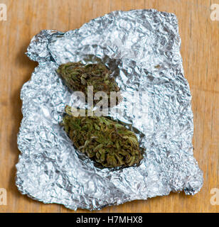 close up on Marijuana in tin foil on table Stock Photo - Alamy