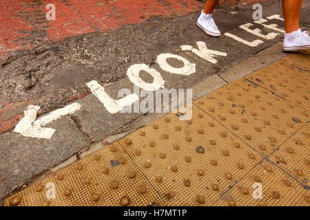 Look left white sign at a pedestrian crossing in London, UK Stock Photo ...