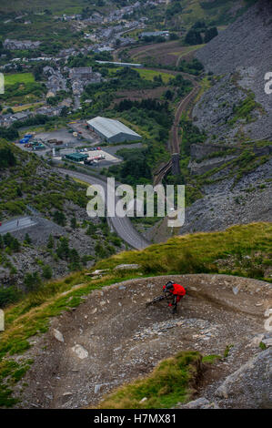 A mountain biker skids round a corner at Antur Stiniog mountain bike ...