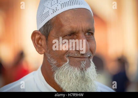 Friendly elderly Indian Muslim man with Islamic beard wears a white ...