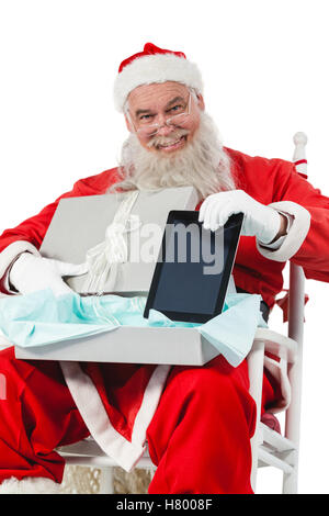 Santa claus removing gift from gift sack in living room at home during ...