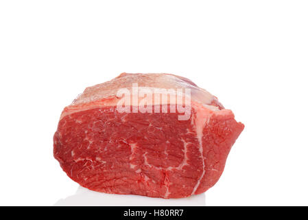 Raw outside Round roast beef meat cut on a marble board. Black ...
