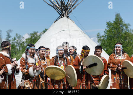 Man and woman in the Koryak national dress stand with tambourines in ...