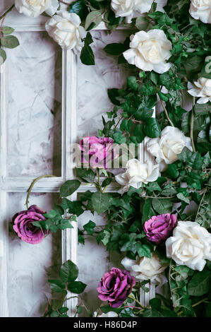 Vintage brown frame with flowers in vase on brown wooden background ...