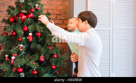 Happy father with his little son in Santa hats having fun at home on ...