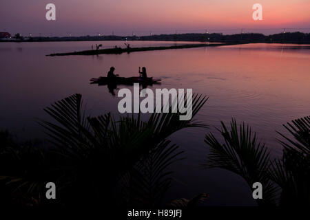 Setting traps for mud crabs in the ponds of a prawn farm that practices ...