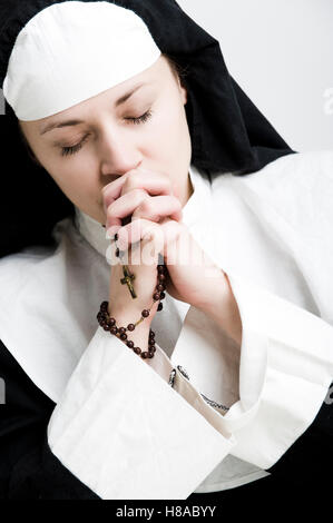 nun praying with closed eyes and hands together isolated on white Stock ...