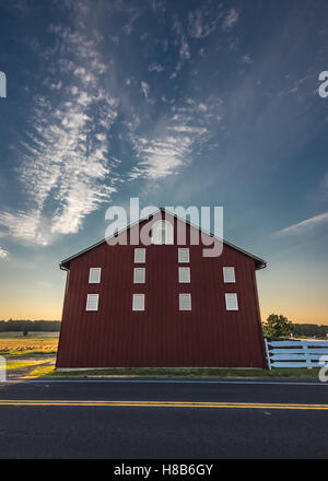 Red Pennsylvania Barn Side At Sunset with white wooden fence Stock ...