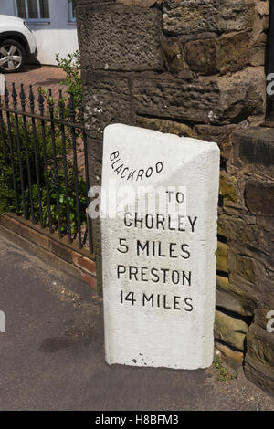 Milestone in the village of Blackrod, near Bolton, Lancashire, showing ...