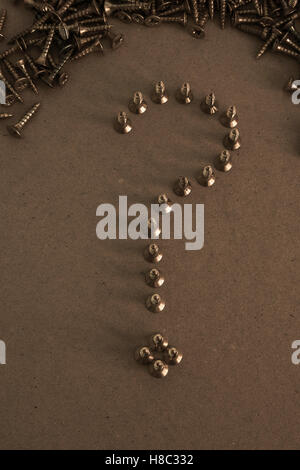 Pile and Line of Screws in shape of Question Mark Stock Photo - Alamy