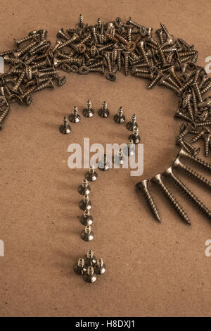Pile and Line of Screws in shape of Question Mark Stock Photo - Alamy