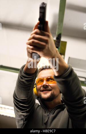 The man at the shooting range. Science use of firearms Stock Photo - Alamy