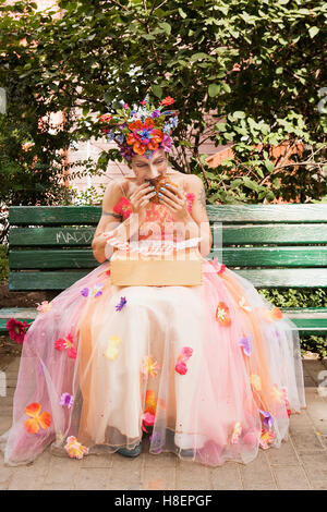 Woman in mime costume with arms raised Stock Photo - Alamy
