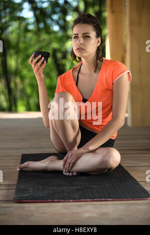 Yoga girl with cup Stock Photo - Alamy