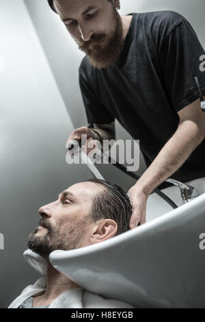 Handsome bearded man washing his face after taking shower Stock Photo ...