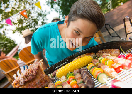 Teenagers during a barbecue at family garden BBQ, outdoor Stock Photo ...