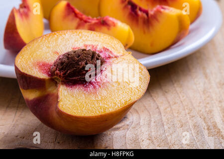 fresh juicy cut peach on steel plate Stock Photo - Alamy