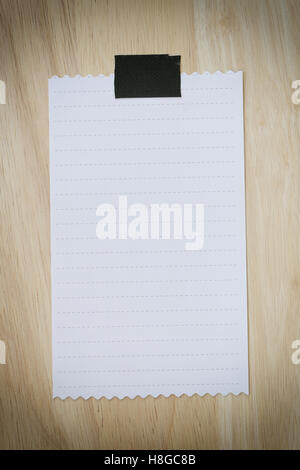 Blank paper notebook on brown wooden table background. Top view with ...