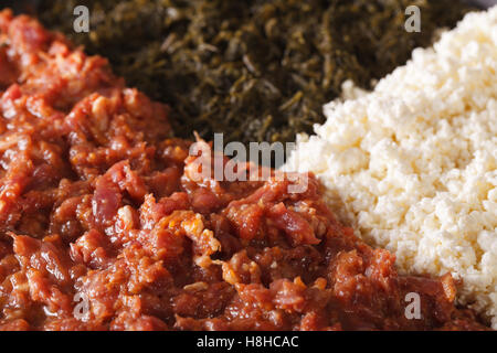 Ethiopian cuisine: kitfo with herbs and cheese on a plate and injera ...