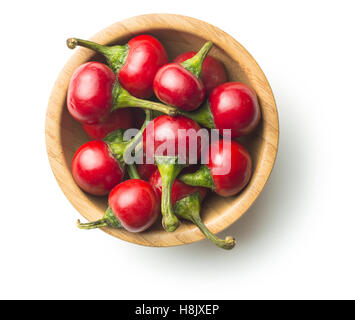 Fresh red chili peppers round slices on wooden cutting board at ...